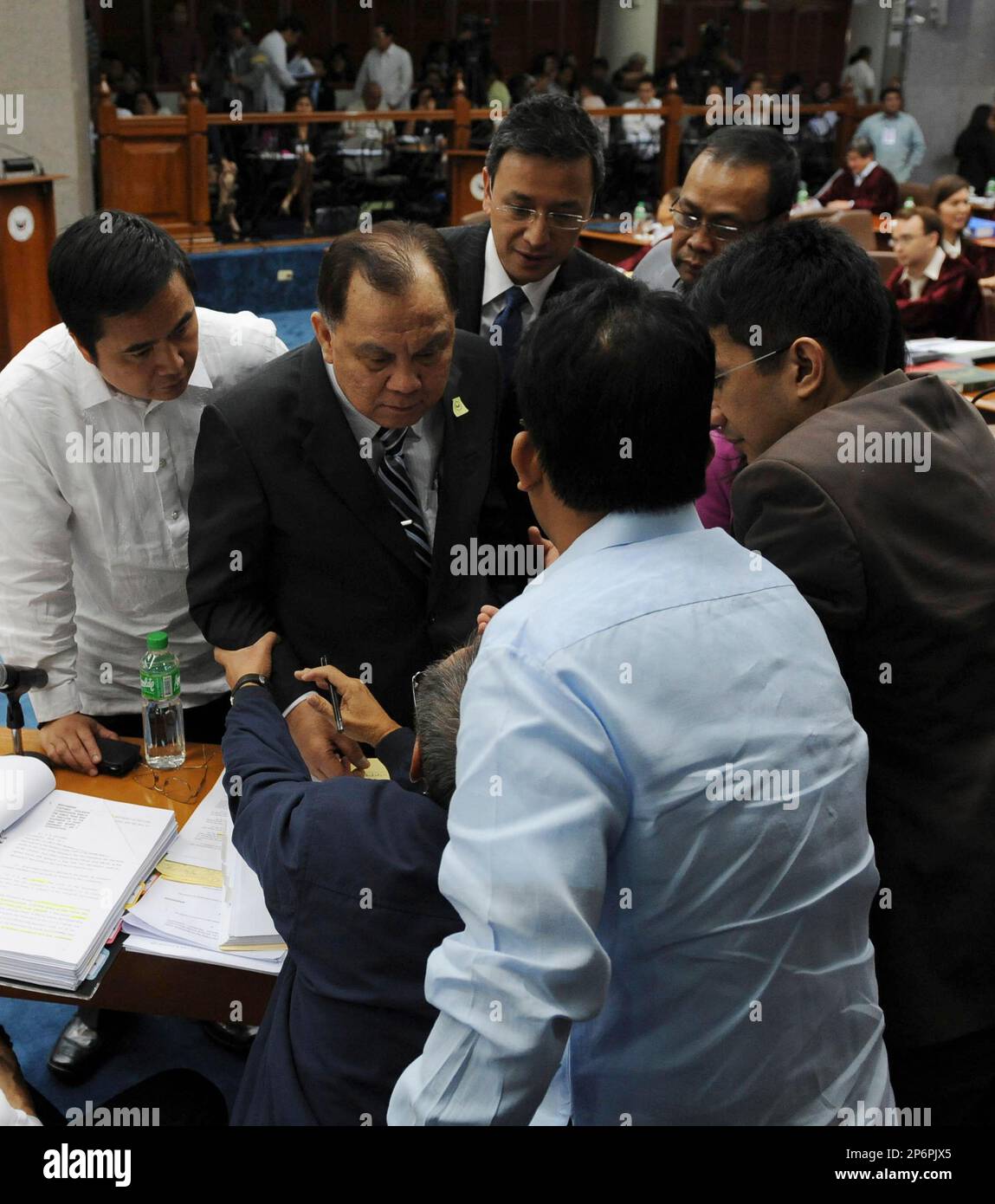 Members of the prosecution panel huddle around during an impeachment ...