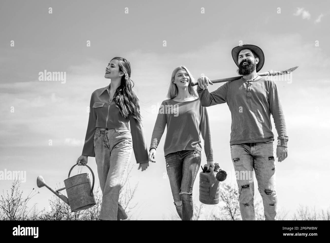 A group of friends enjoy the spring nature and take care of the plants ...