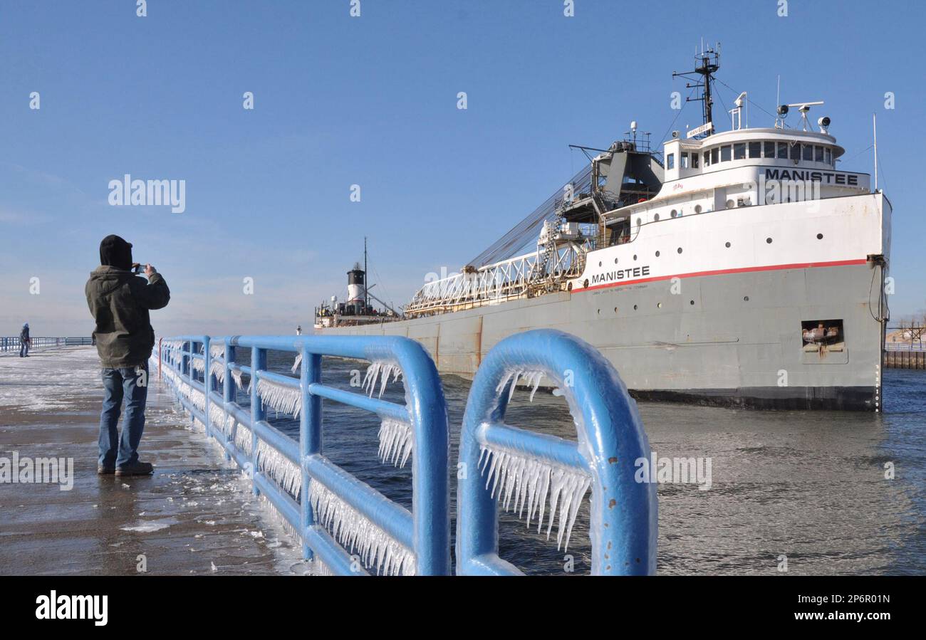 A photographer on the south pier in St. Joseph, Mich., snaps a photo of ...