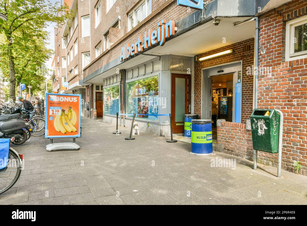 Amsterdam, Netherlands - 10 April, 2021: a bike parked on the side of a street in front of a ...