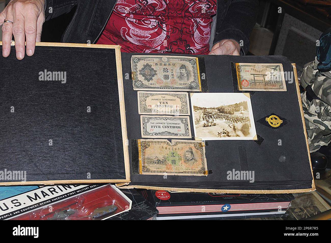 This ledger, featuring several pieces of Japanese currency and ...