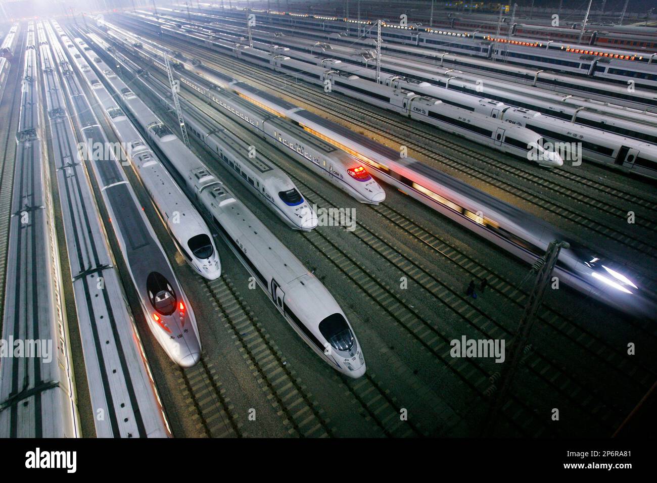 China's CRH high-speed trains sit on tracks at a maintenance base in ...