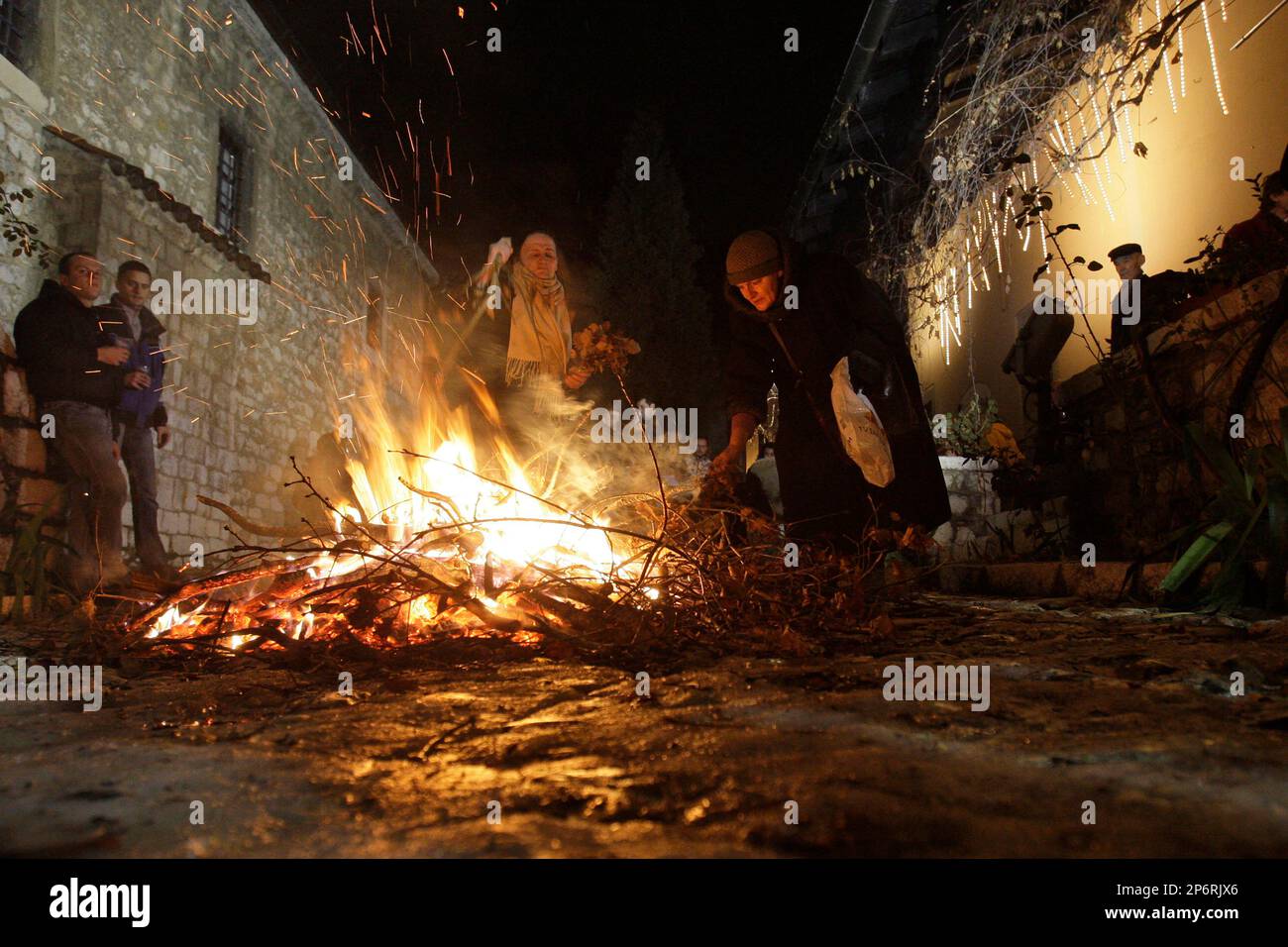 Bosnian Serb people gather around a fire of the dried oak branches, the ...