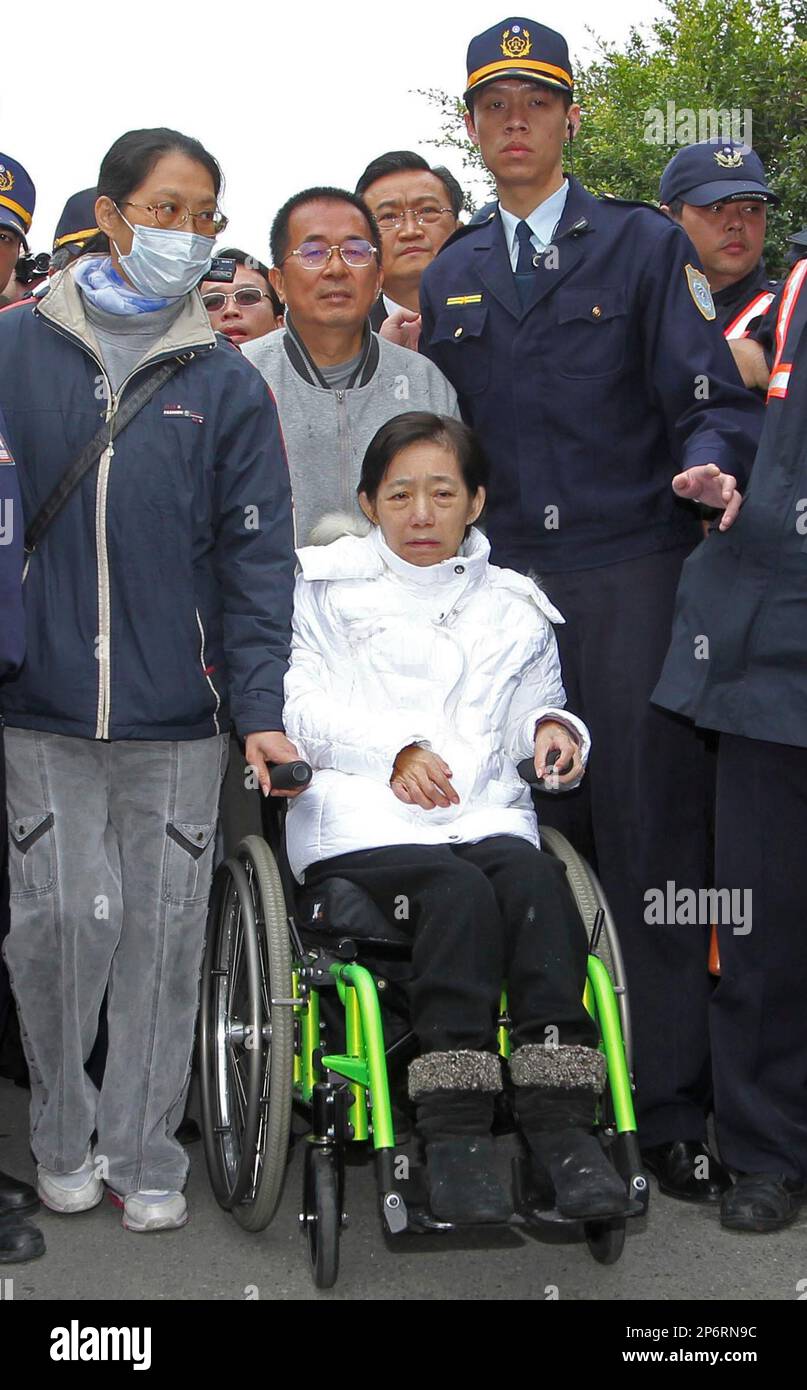 Taiwan's jailed former president Chen Shui-bian pushes the wheelchair of his wife Wu Shu-chen ...