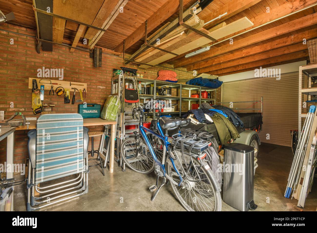 a garage with many bikes parked in the garage, and one bike is leaning ...