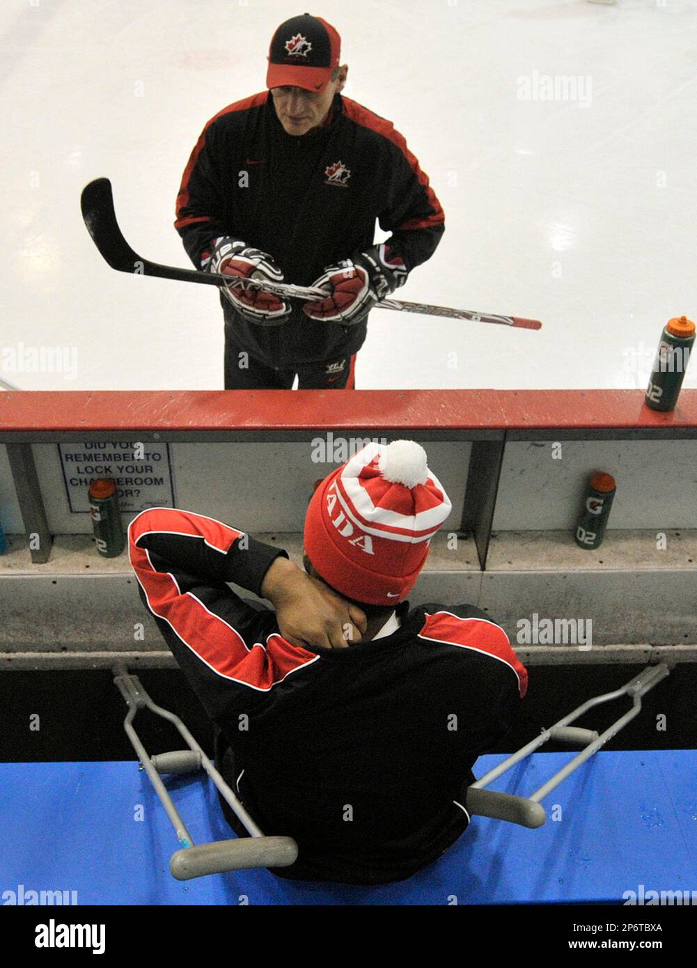 Injured Team Canada forward Devante Smith-Pelly talks to coach Don Hay ...