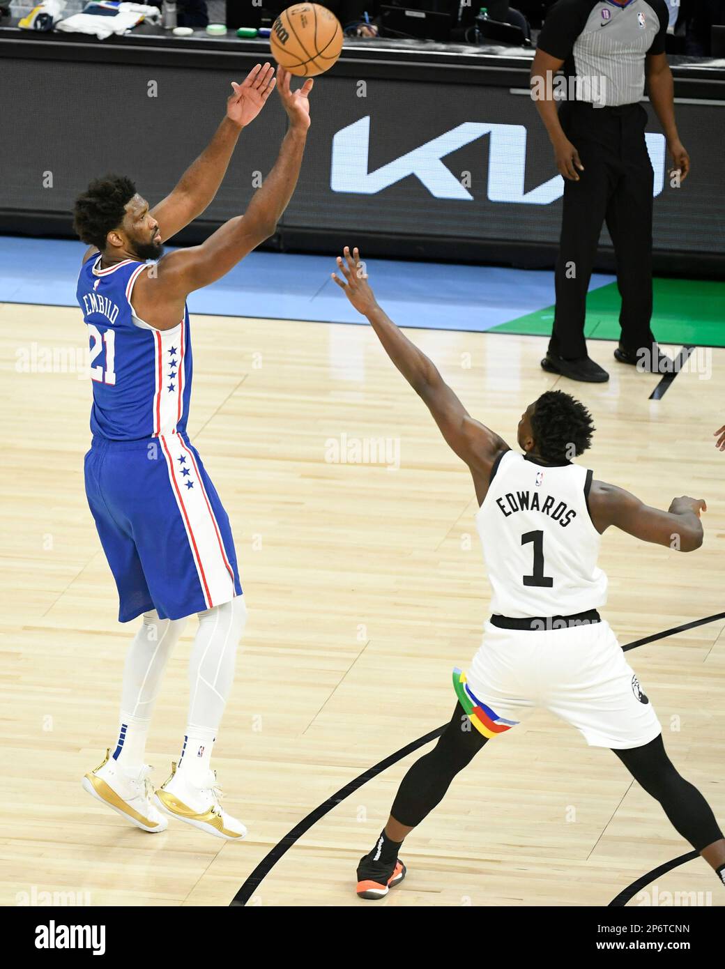Philadelphia 76ers center Joel Embiid (21) takes a shot over Minnesota Timberwolves guard ...