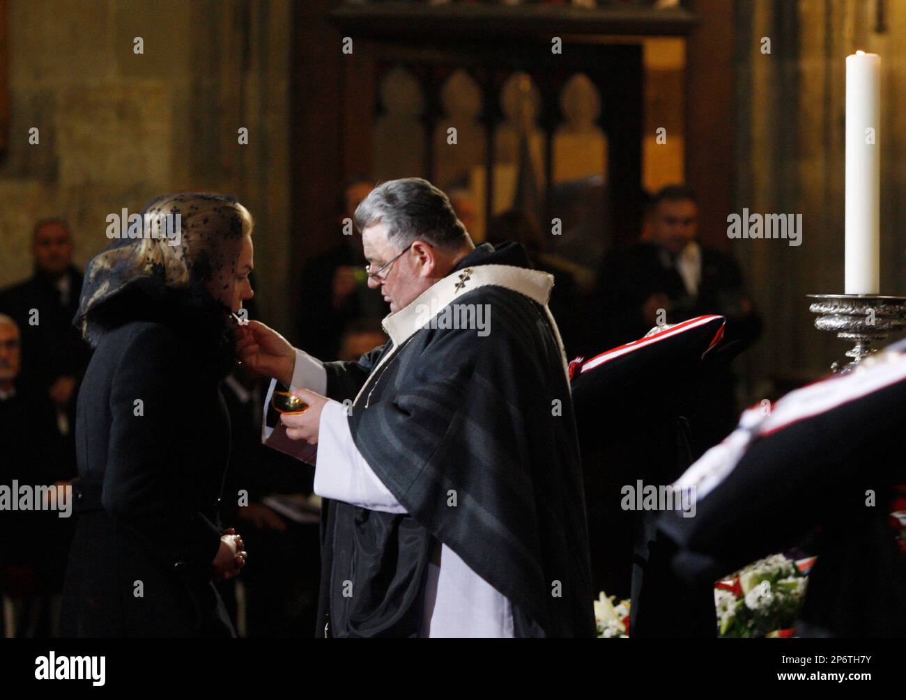 Prague Archbishop Dominik Duka, right, gives the communion to Havel's ...