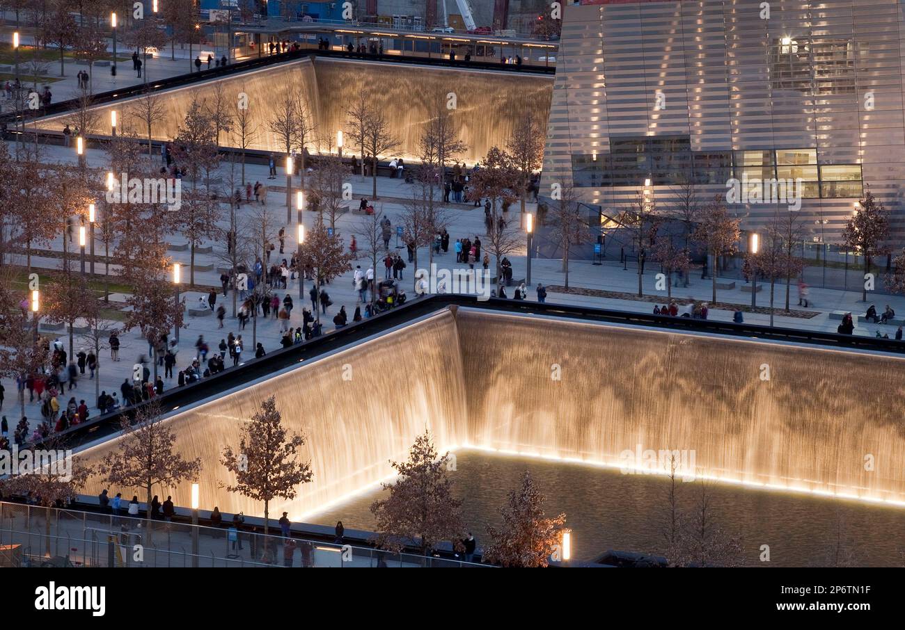 Visitors to the National September 11 Memorial walk around the twin ...