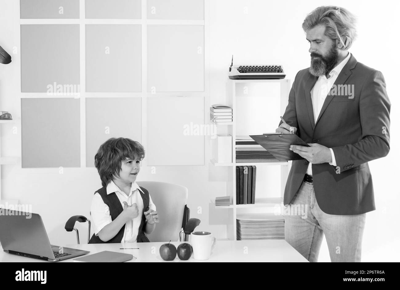 Businessman father with his son drawing on business papers at office ...