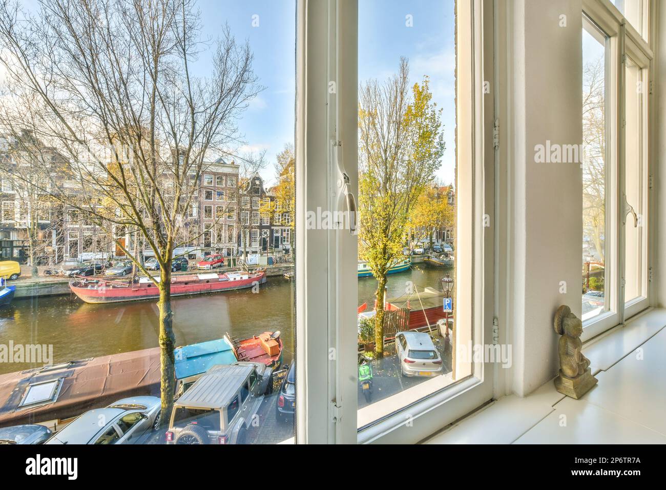 some boats in the water from a window sing it's not clear, but there is ...