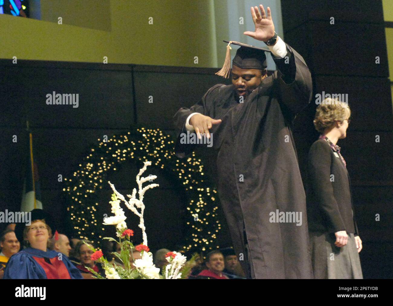 Graduate Jeremy Woods celebrates as he walks across stage to receive ...
