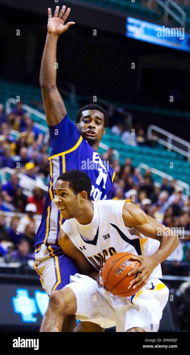 UNC-Greensboro's Trevis Simpson drives against East Carolina's Corvonn ...