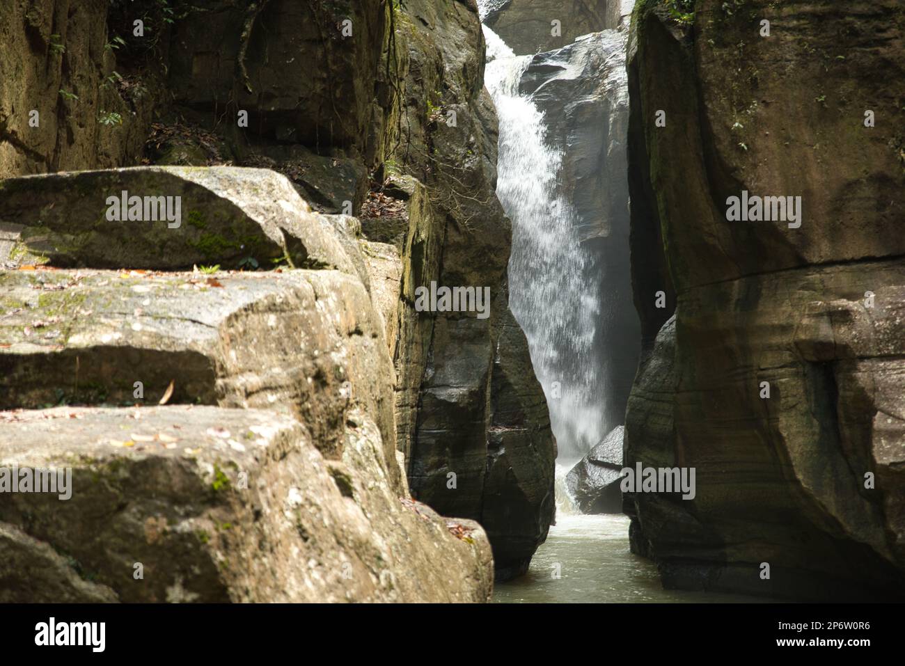 Shot of Cunca Wulang waterfall on Flores, photographed through a rocky ...