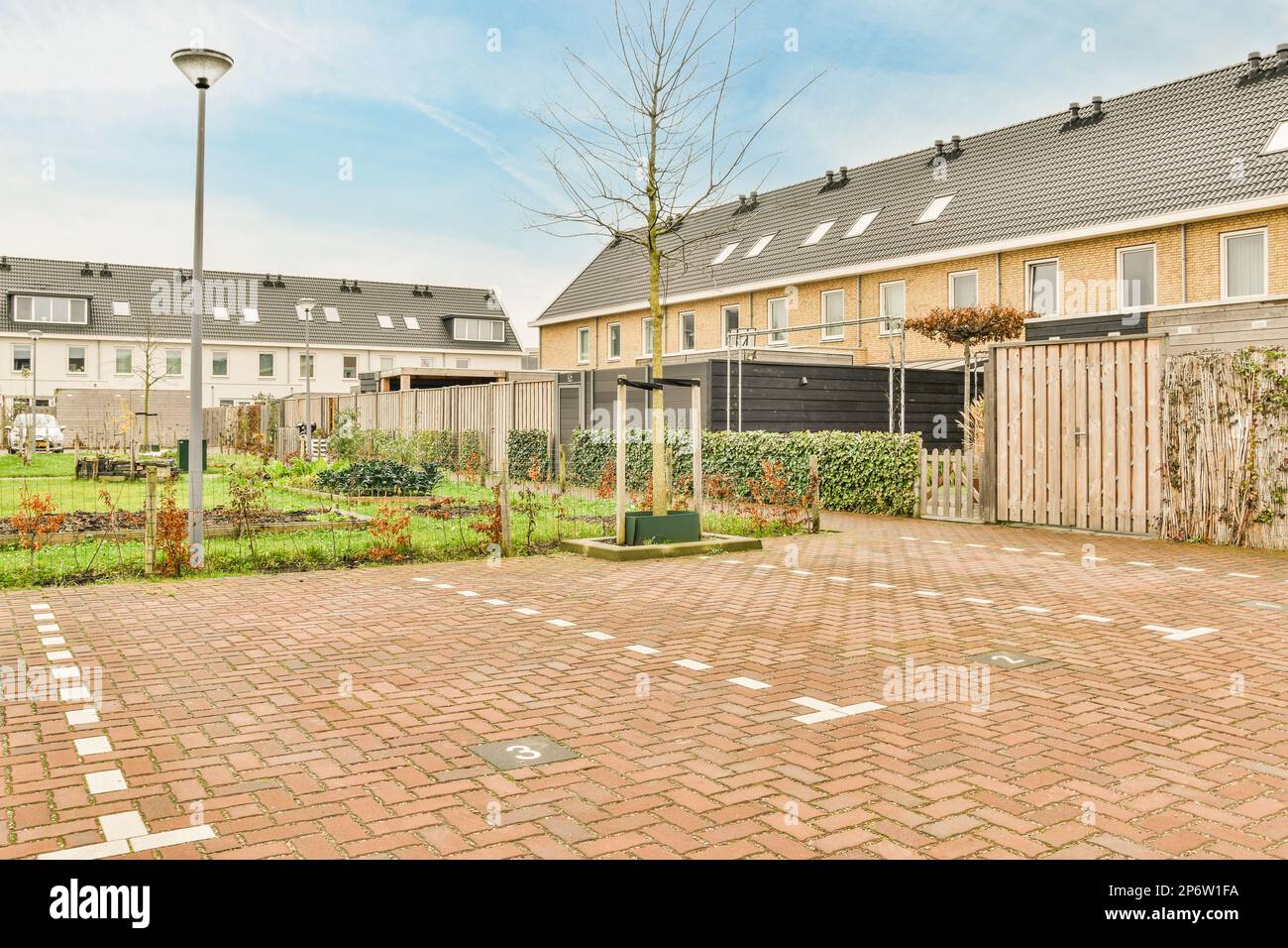 an outside area with brick pavers and trees in the fore - image is ...