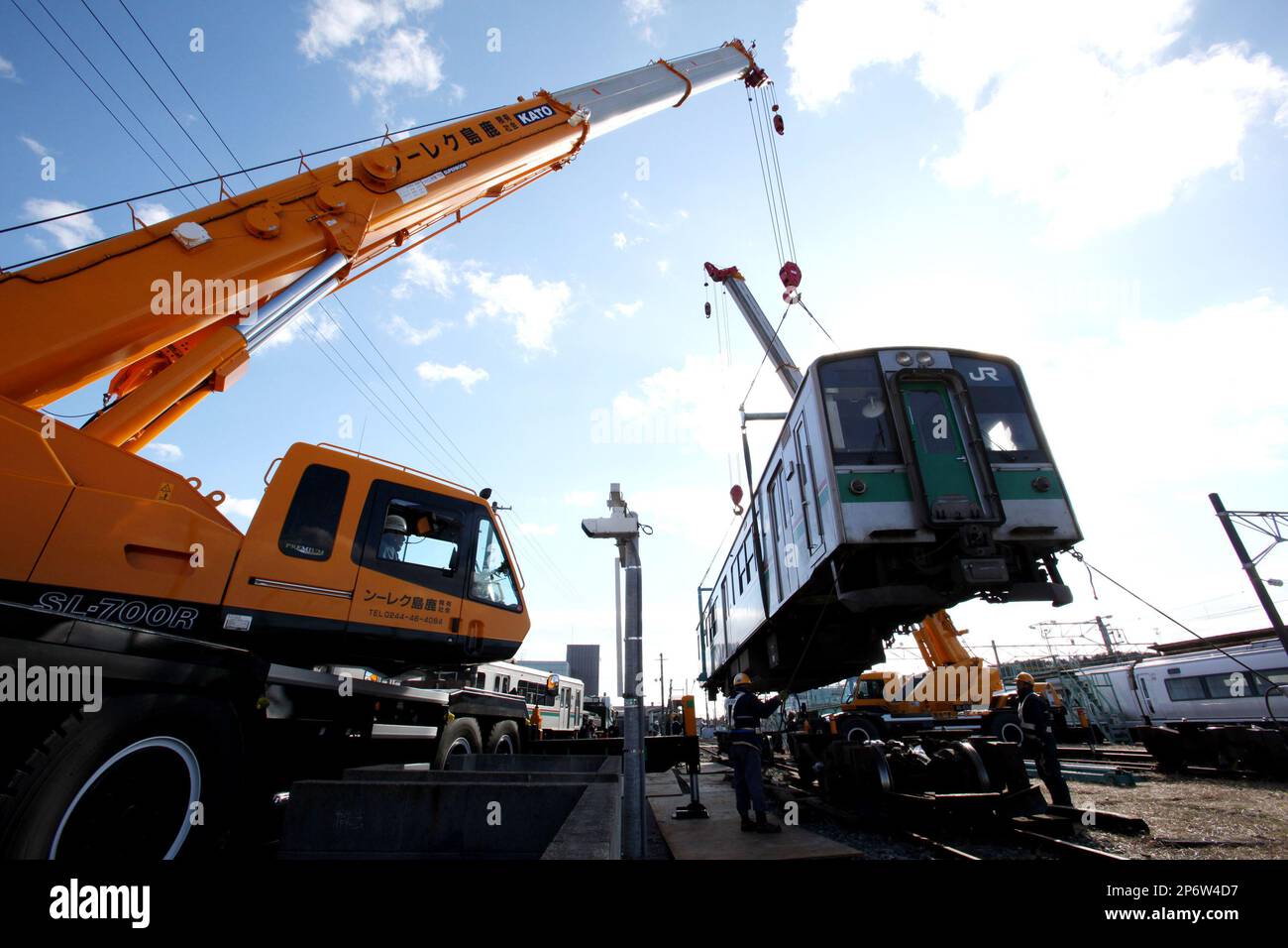 Rolling stock used on the JR Joban Line is lowered onto railway tracks ...