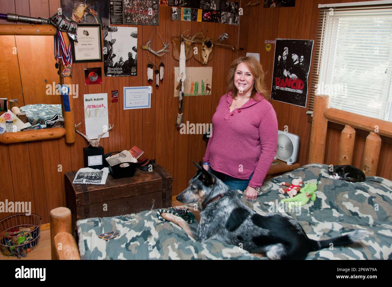 Linda Osier and Simon pose for a portrait in her son's, Tommy, room at ...