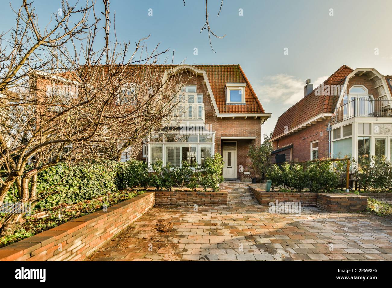 a nice house in the day time with blue sky and sun shining through the ...