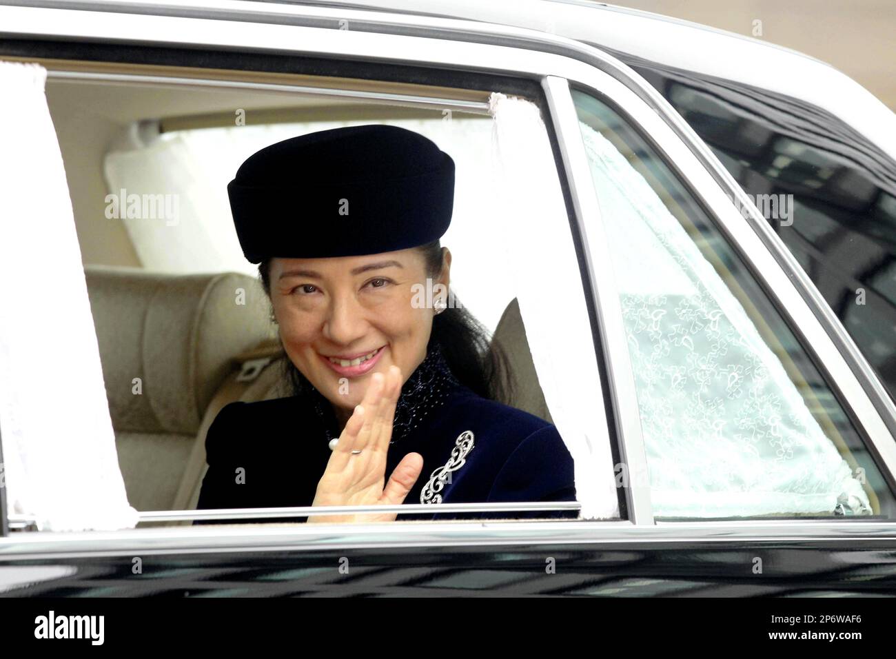 Crown Princess Masako of Japan waves her hand out of the window of the ...