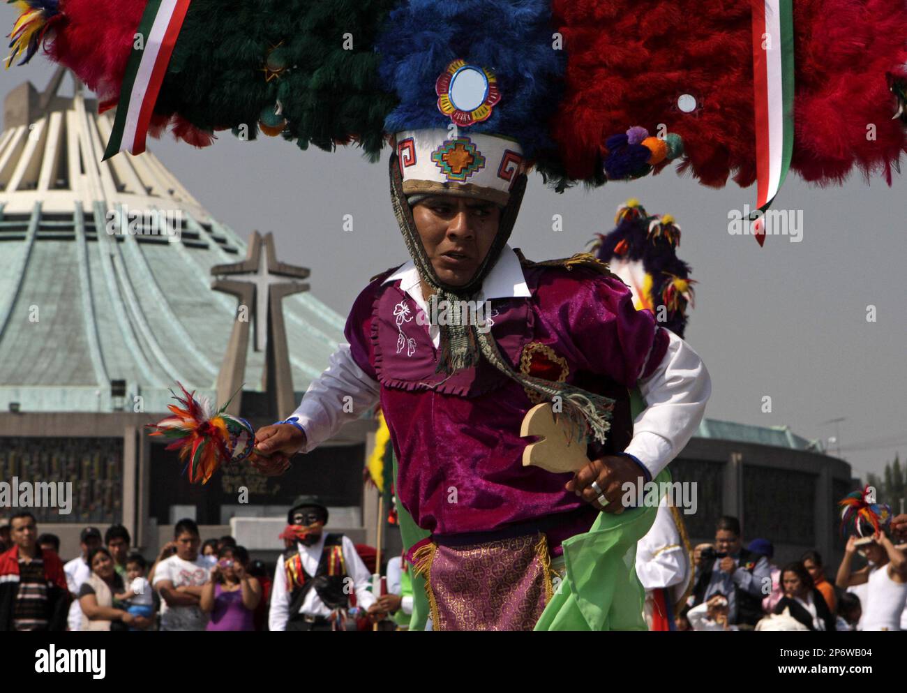 Pilgrims gather to watch a group of Mixtec Indian dancers perform a ...