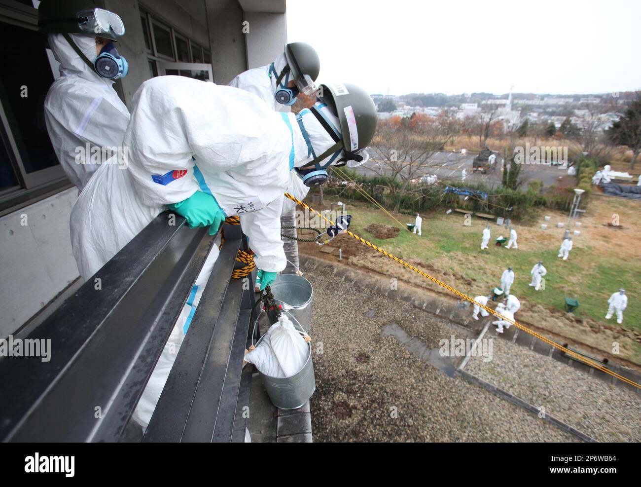 Members of Japan Ground Self-Defense Force (JGSDF) remove gravel by ...