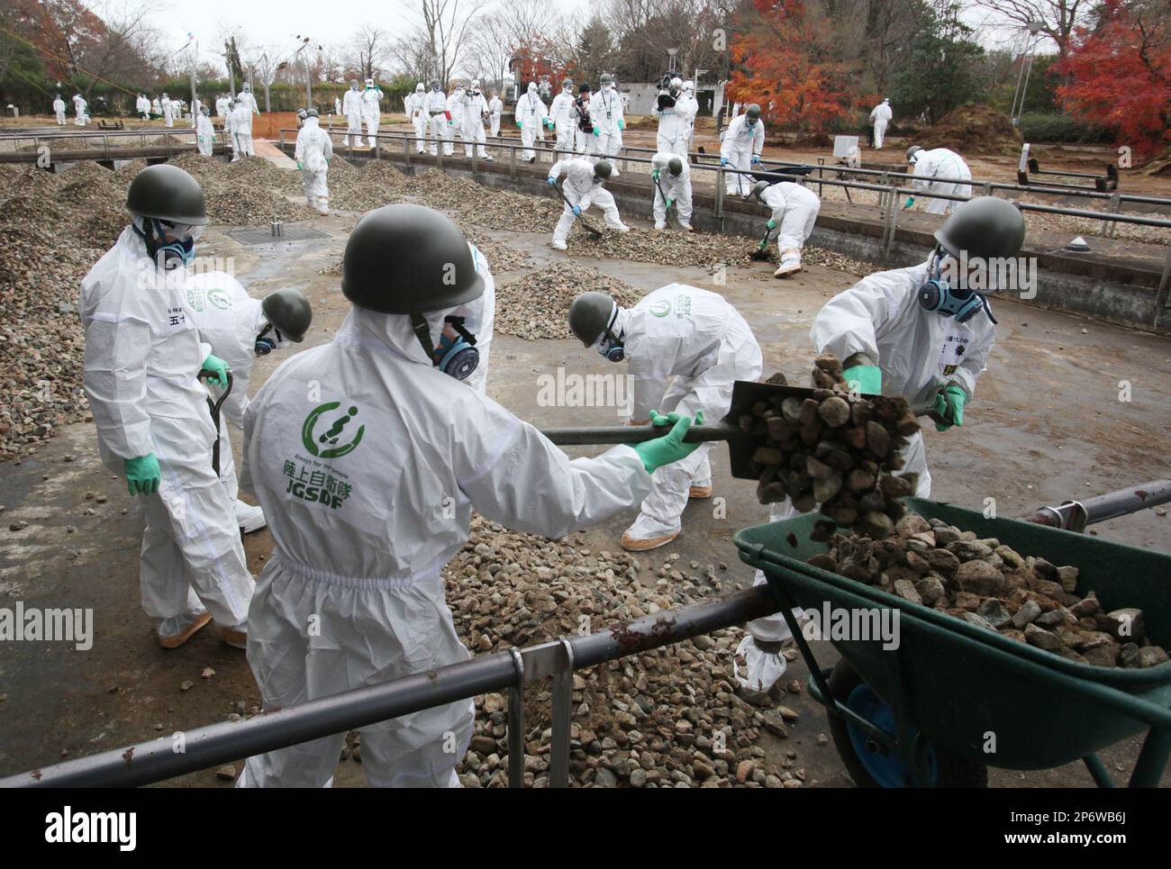 Members of Japan Ground Self-Defense Force (JGSDF) remove soil and ...