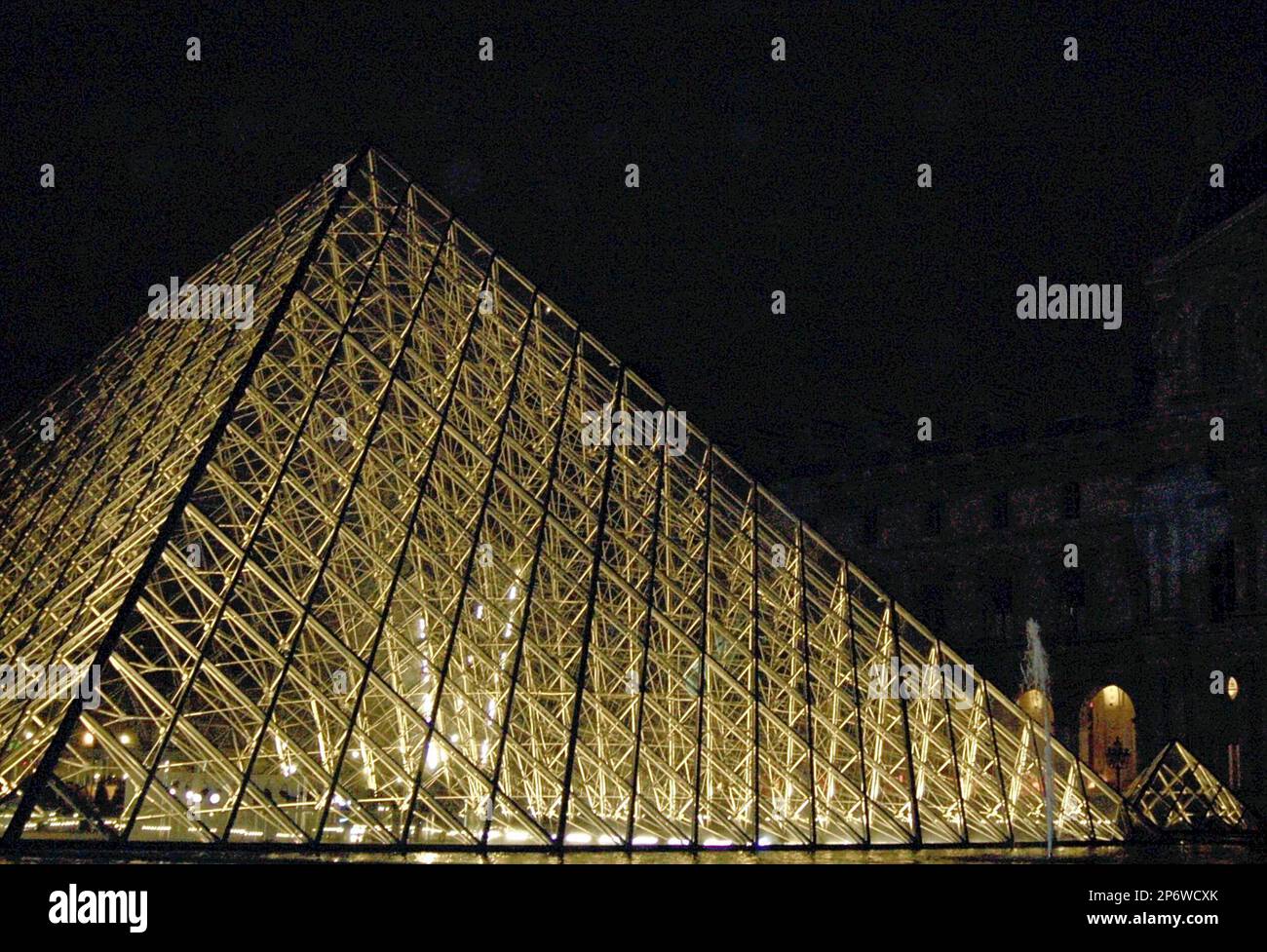 A new lighting of the Louvre museum glitters in the night at Paris ...