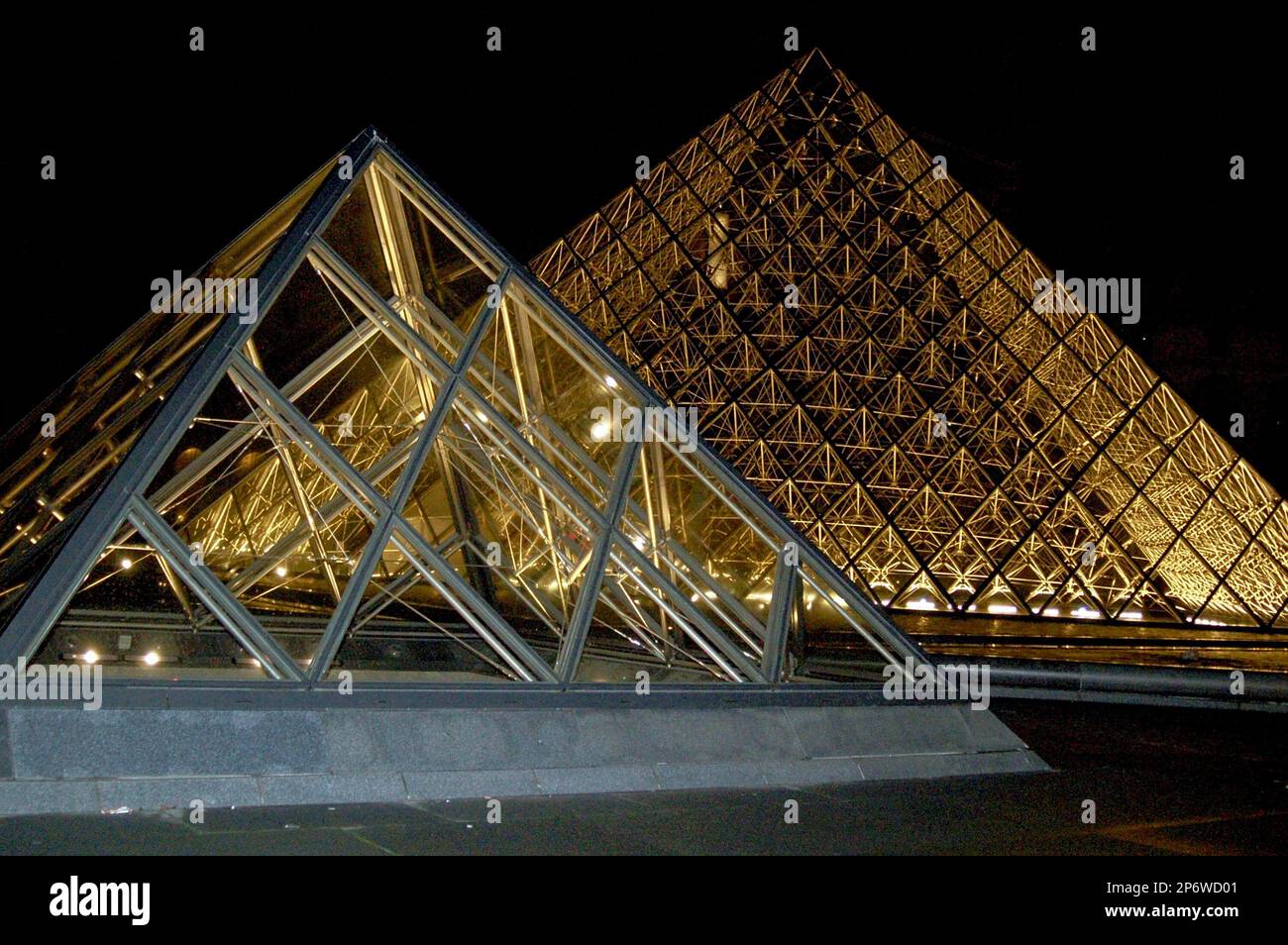 A new lighting of the Louvre museum glitters in the night at Paris ...