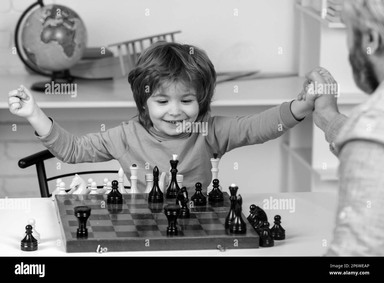 Young kid boy playing chess with father and having fun. Educational ...