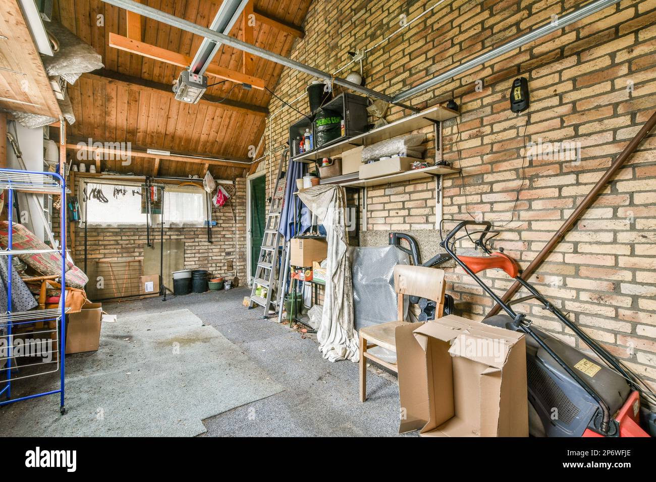 a garage with boxes, tools and other things on the floor in front of ...