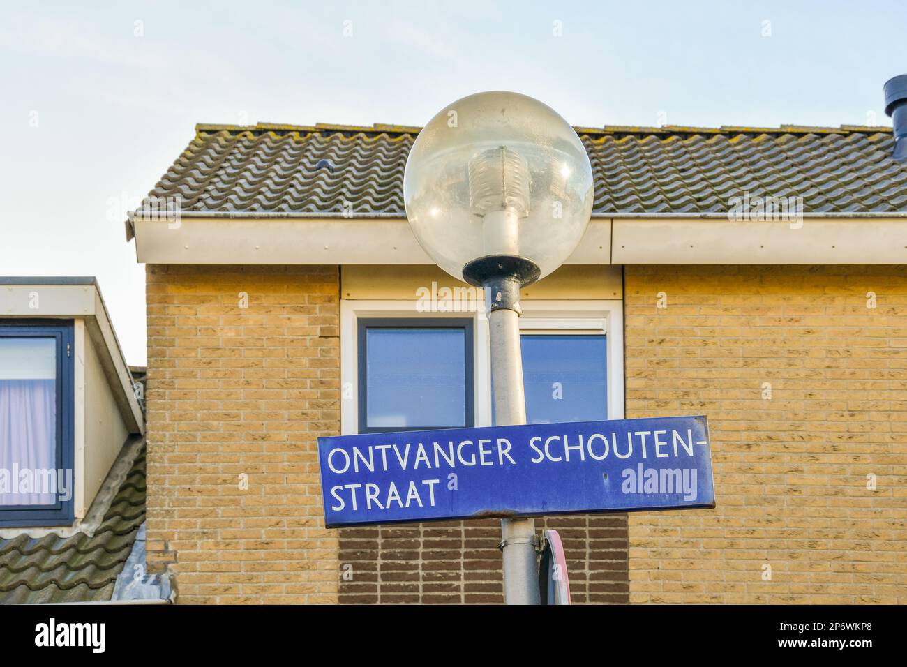 a street sign in front of a brick building with the words on it and an ...
