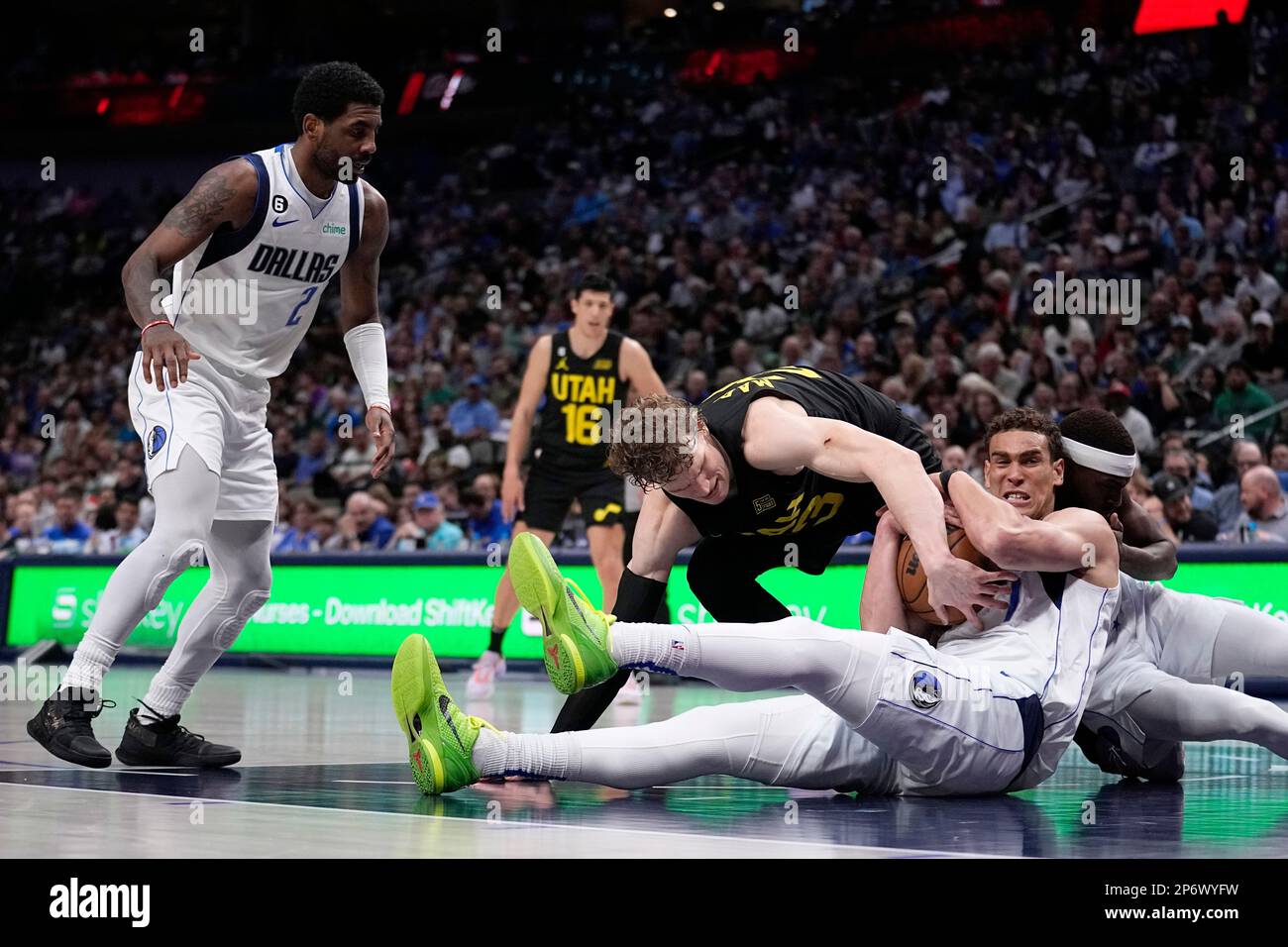 Dallas Mavericks' Dwight Powell, center, Justin Holiday, right, and ...