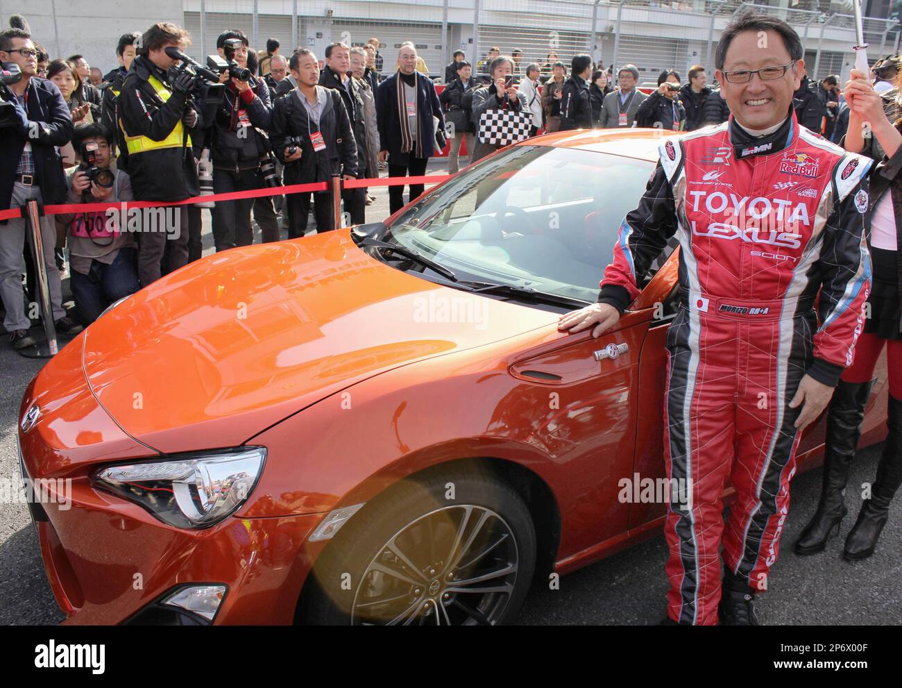Toyota Motor Corp. President Akio Toyoda wearing a racing suit smiles ...