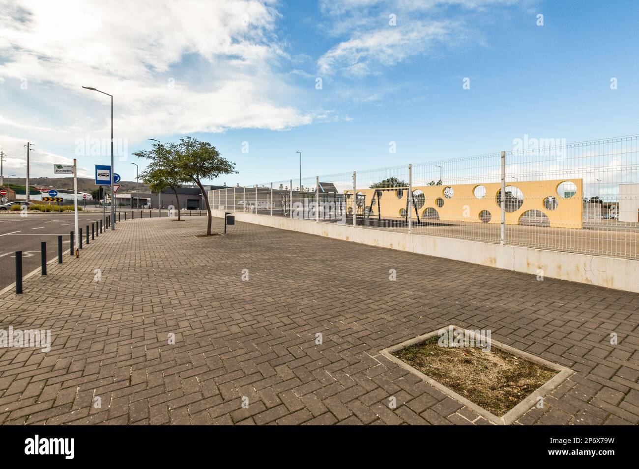 a brick paved street in the middle of an urban area with buildings and ...