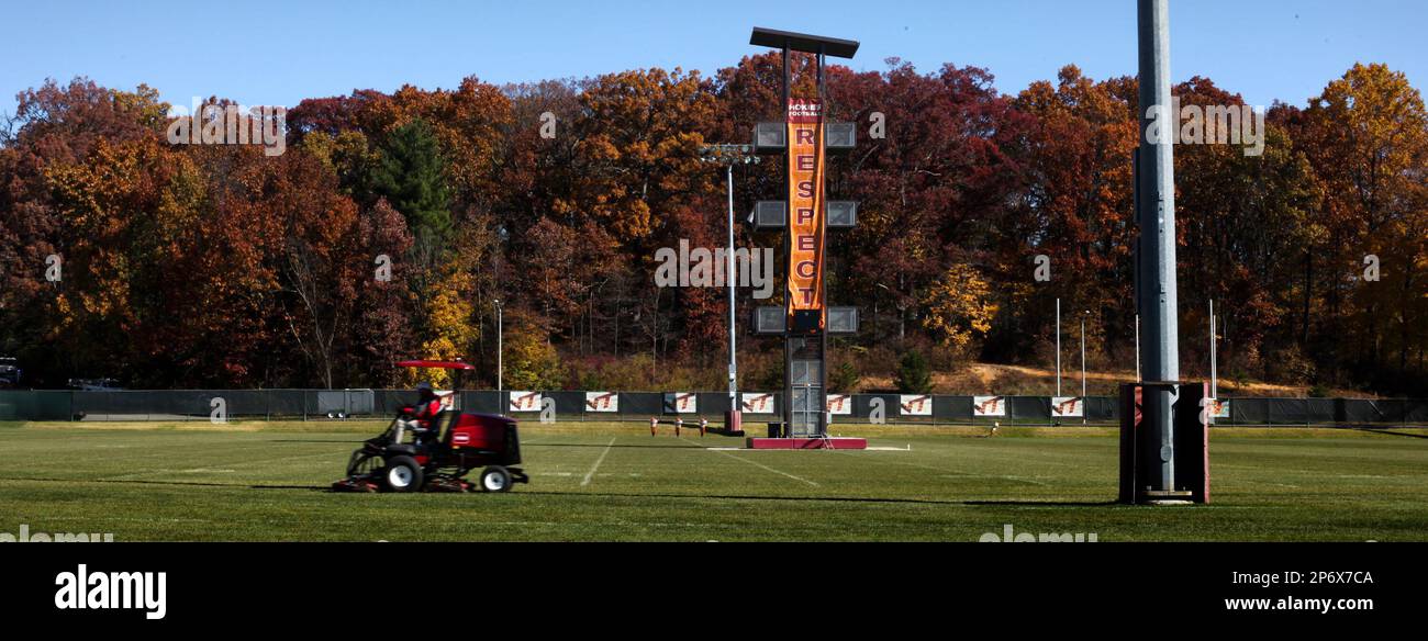 A facilities worker mows the Virginia Tech football practice fields in ...