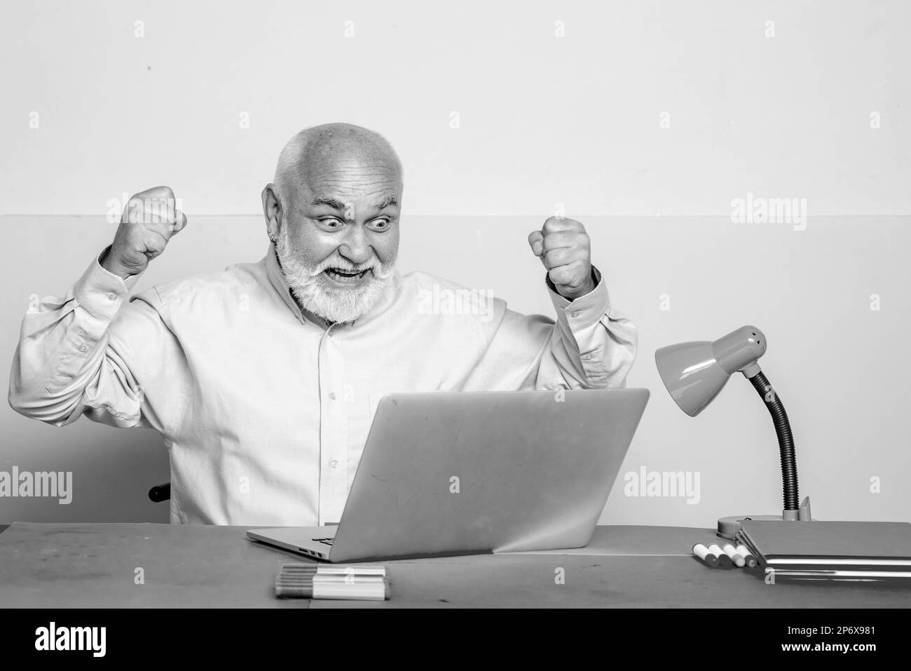 Excited Old businessmen using notebook at meeting. Old manager having ...