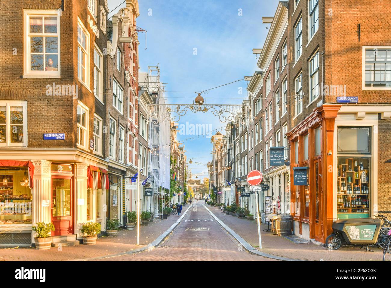 an empty street in the middle of a city with buildings on both sides ...
