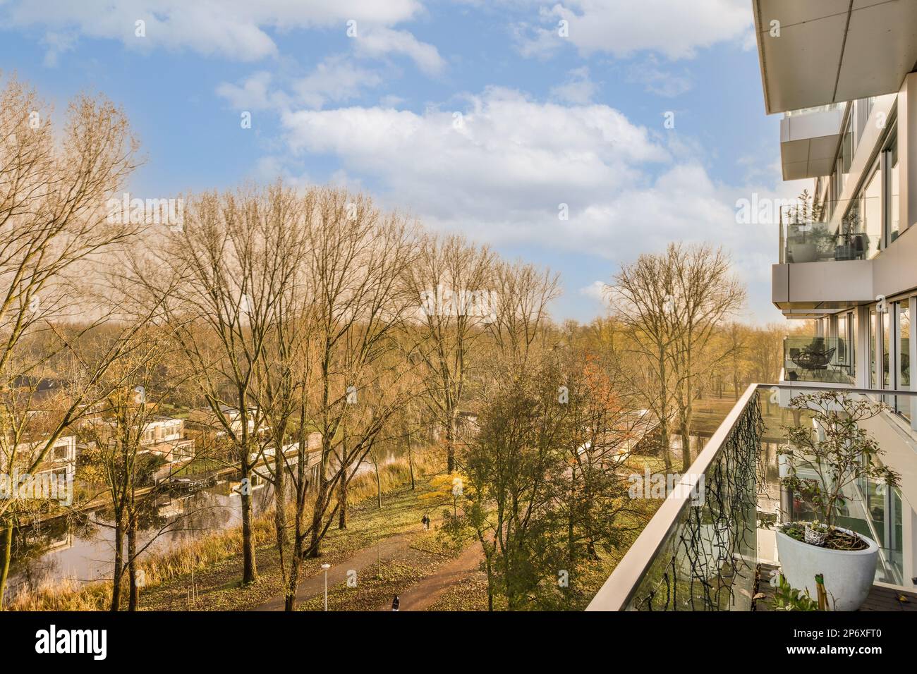 a balcony with trees in the background and blue sky above, as seen from ...