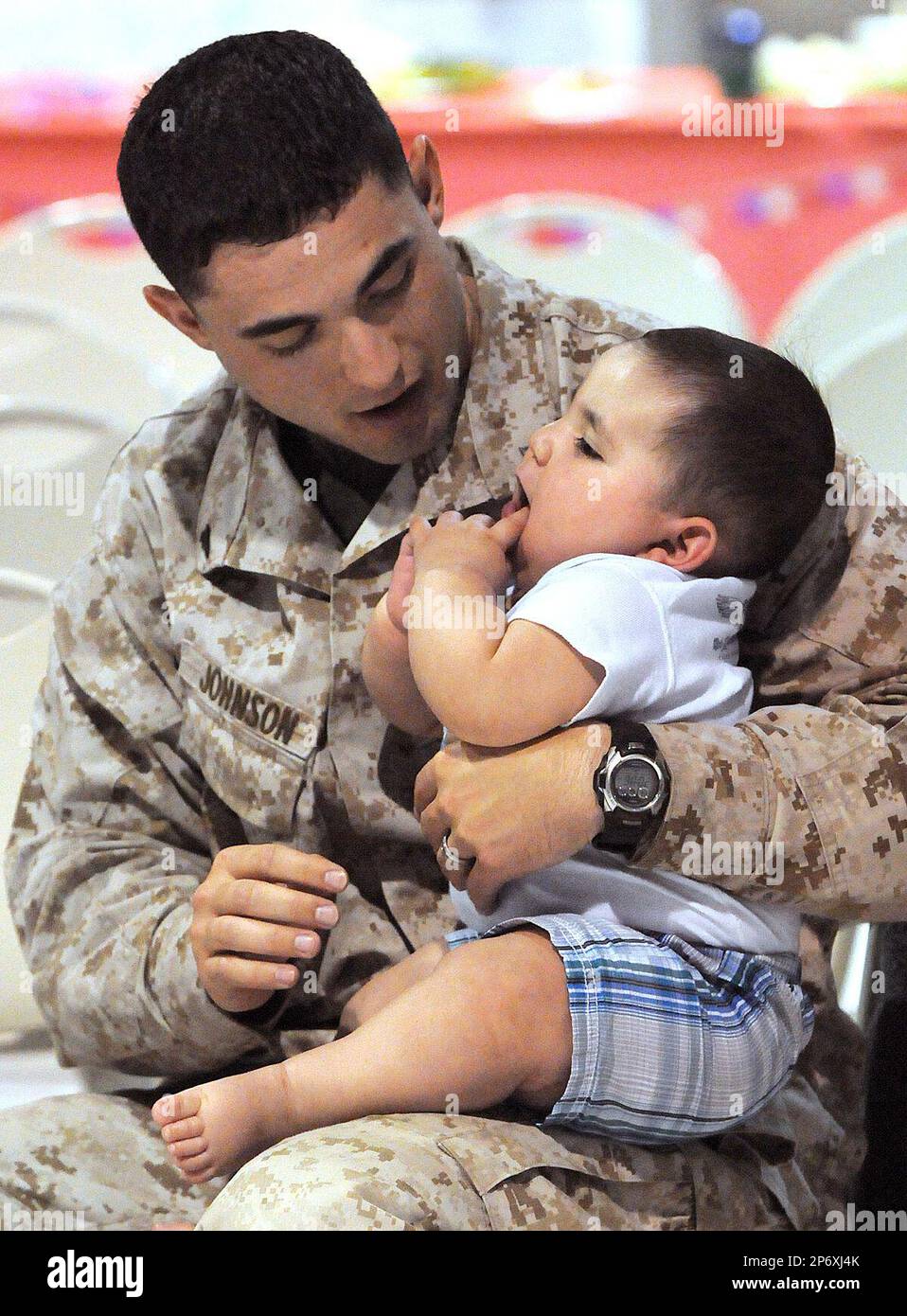 U.S. Marine Corps Cpl. Tyler Johnson checks out his son, six-month-old ...