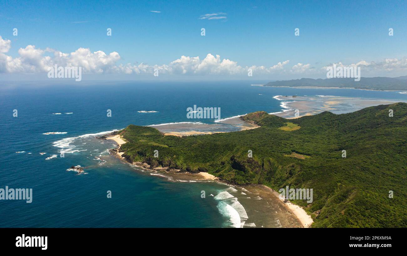 Top view of tropical island with jungle and blue sea. Cape Engano ...