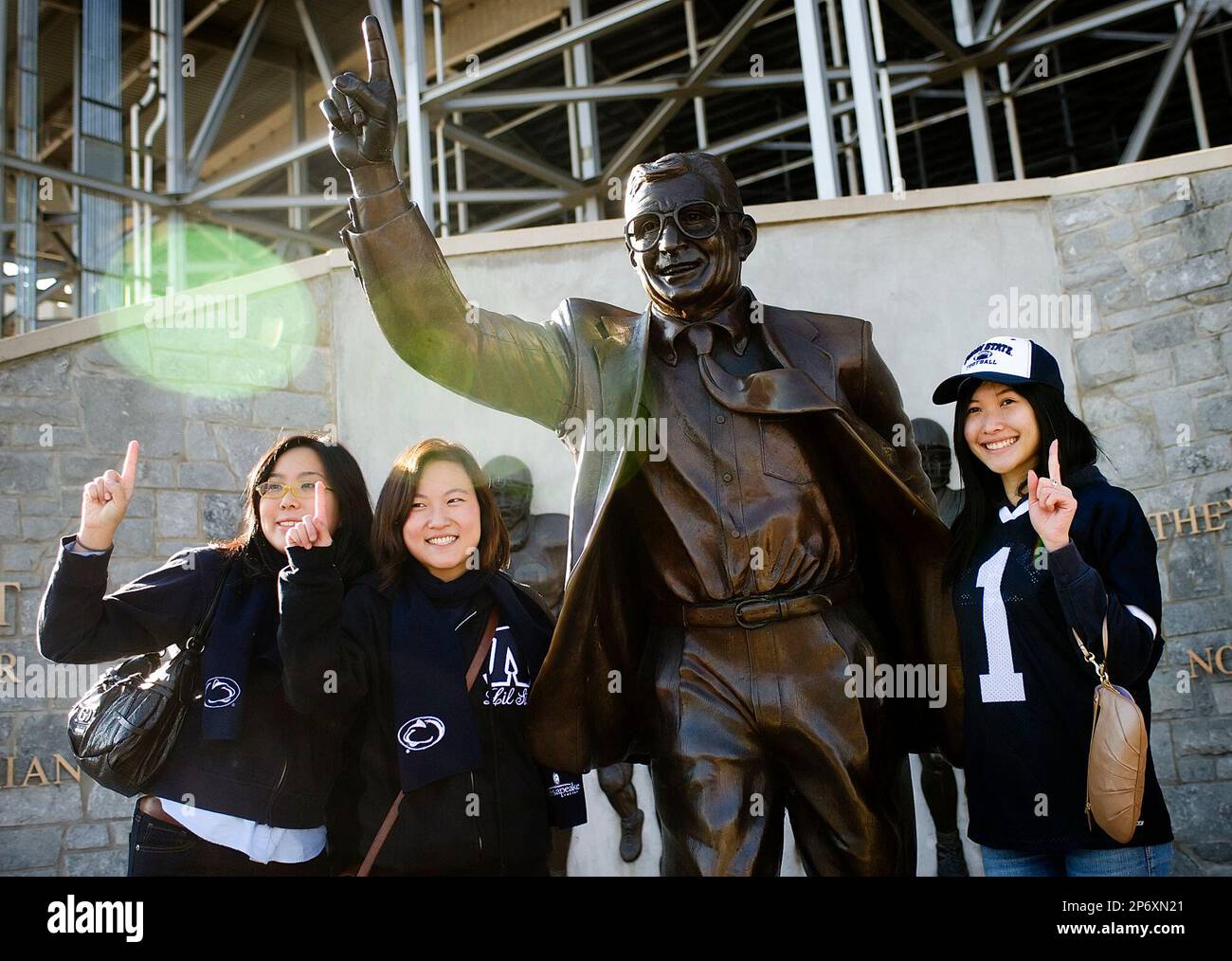 Penn State fans pose for a picture with the Joe Paterno statue at ...
