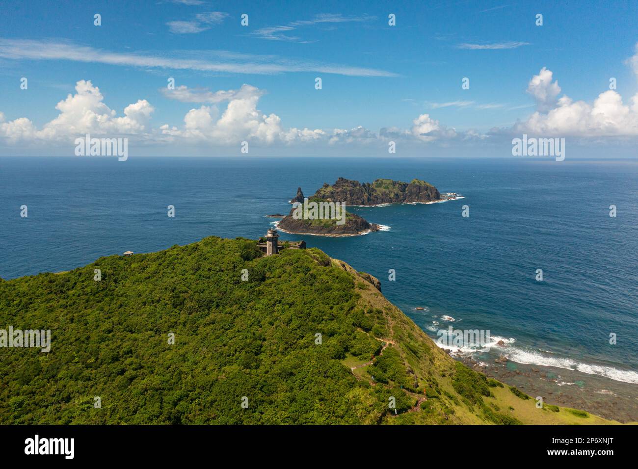 Aerial view of Lighthouse on a cape against the backdrop of tropical ...