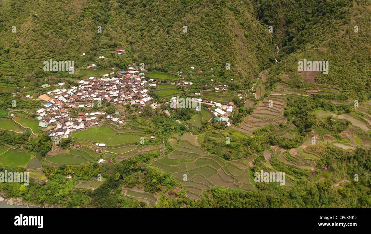 Aerial view of village among rice terraces and fields in the mountains ...