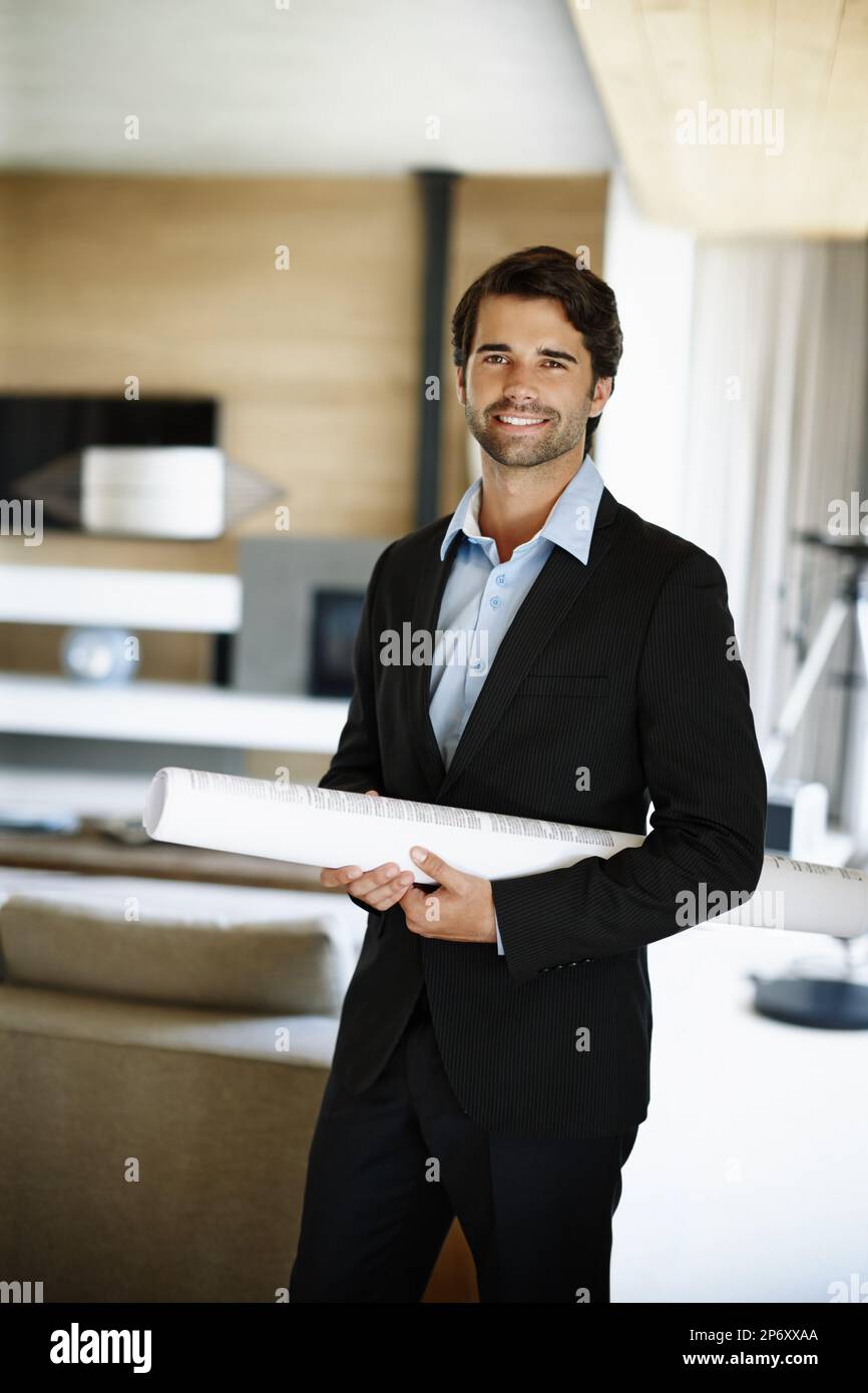 Prepared to present his building designs. A handsome young architect ...