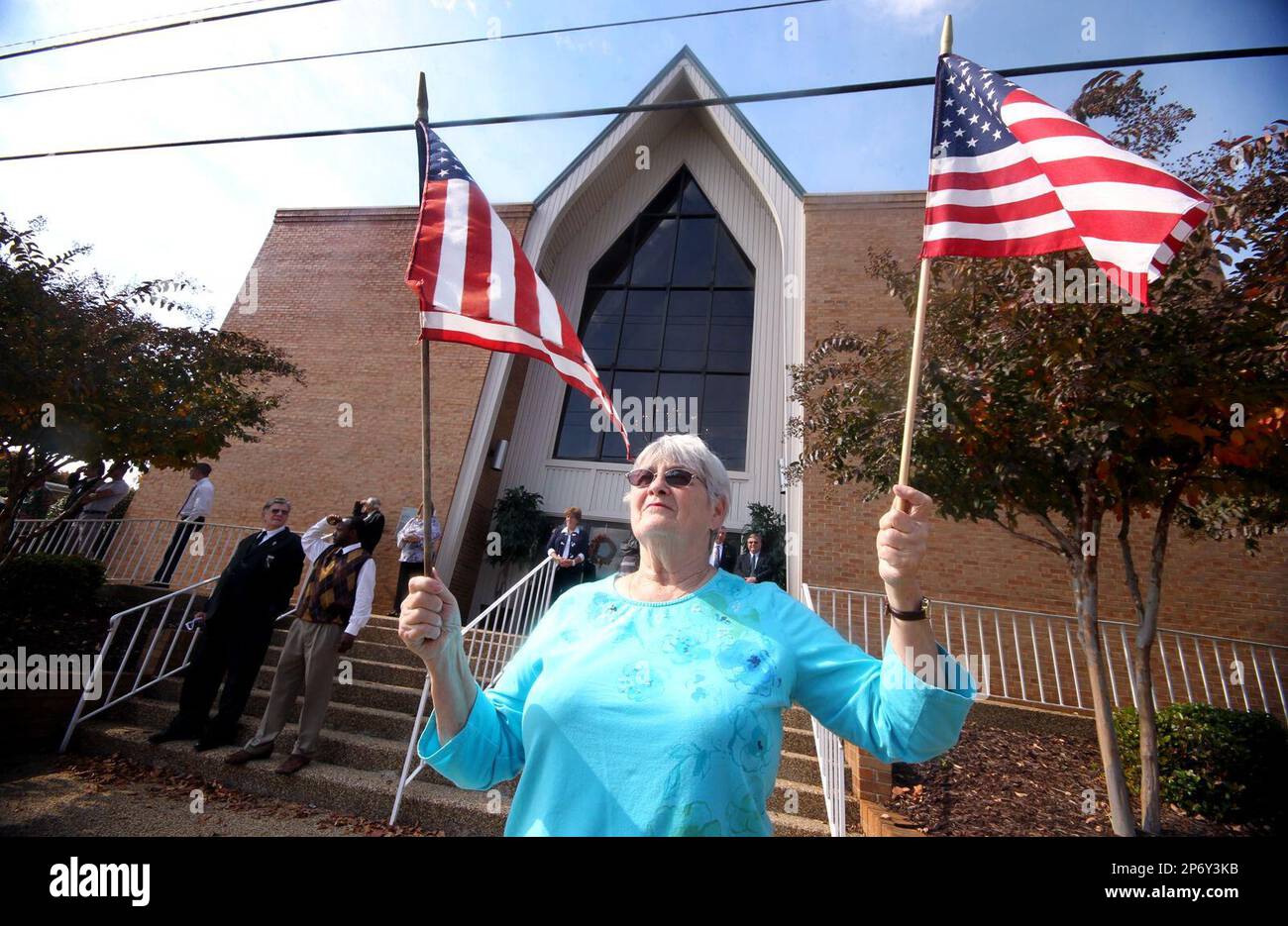 Mabel Shepherd waves American flags outside Bethel Baptist Church in ...