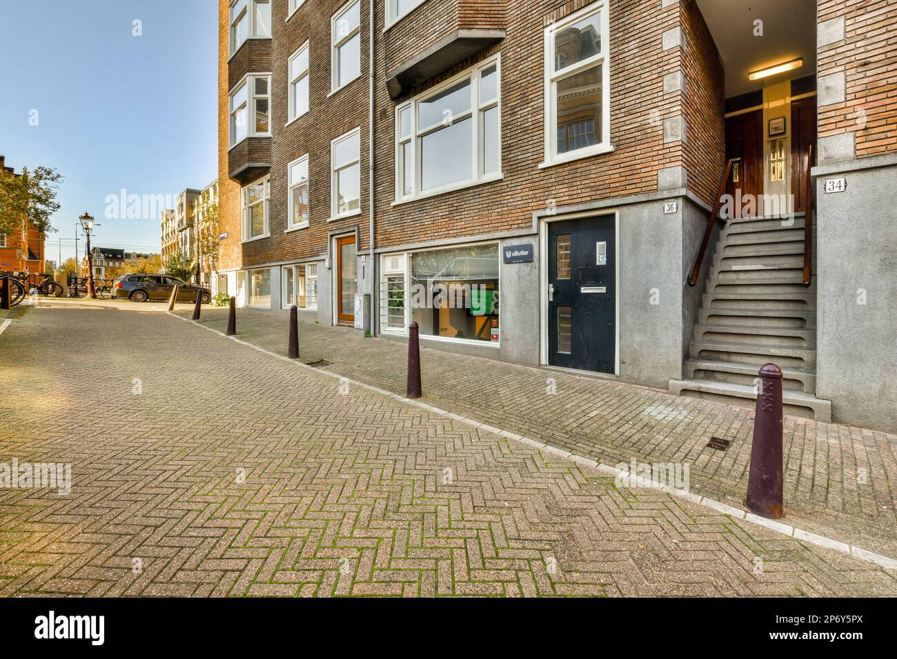 a bricked street in the middle of an urban area with buildings on both ...