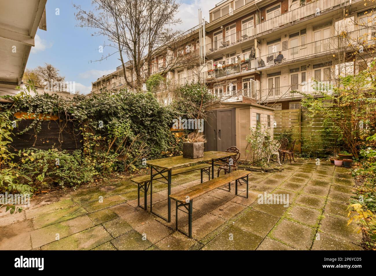 an outdoor area with tables and benches in the middle part of the yard ...