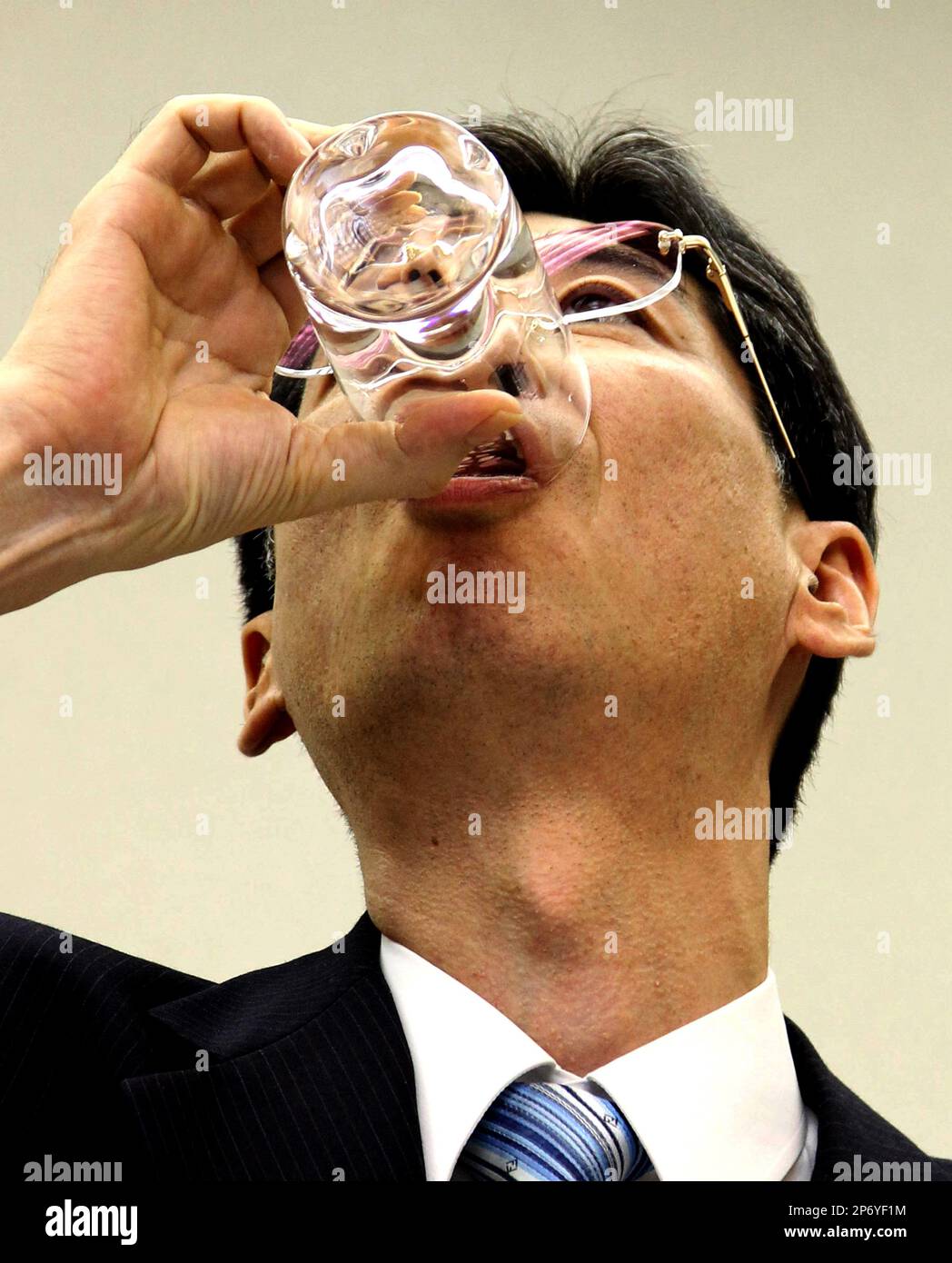 Yasuhiro Sonoda, a lawmaker drinks a glaas of decontaminated water ...