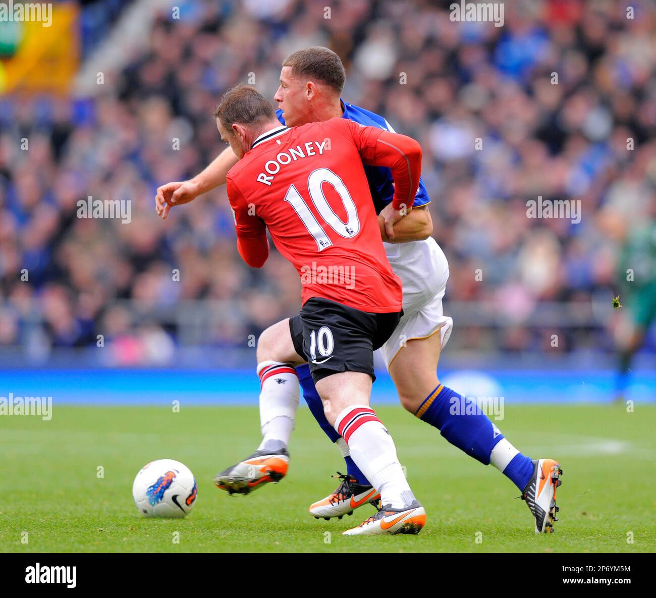 Wayne Rooney of Manchester United tussles with Ross Barkley of Everton ...