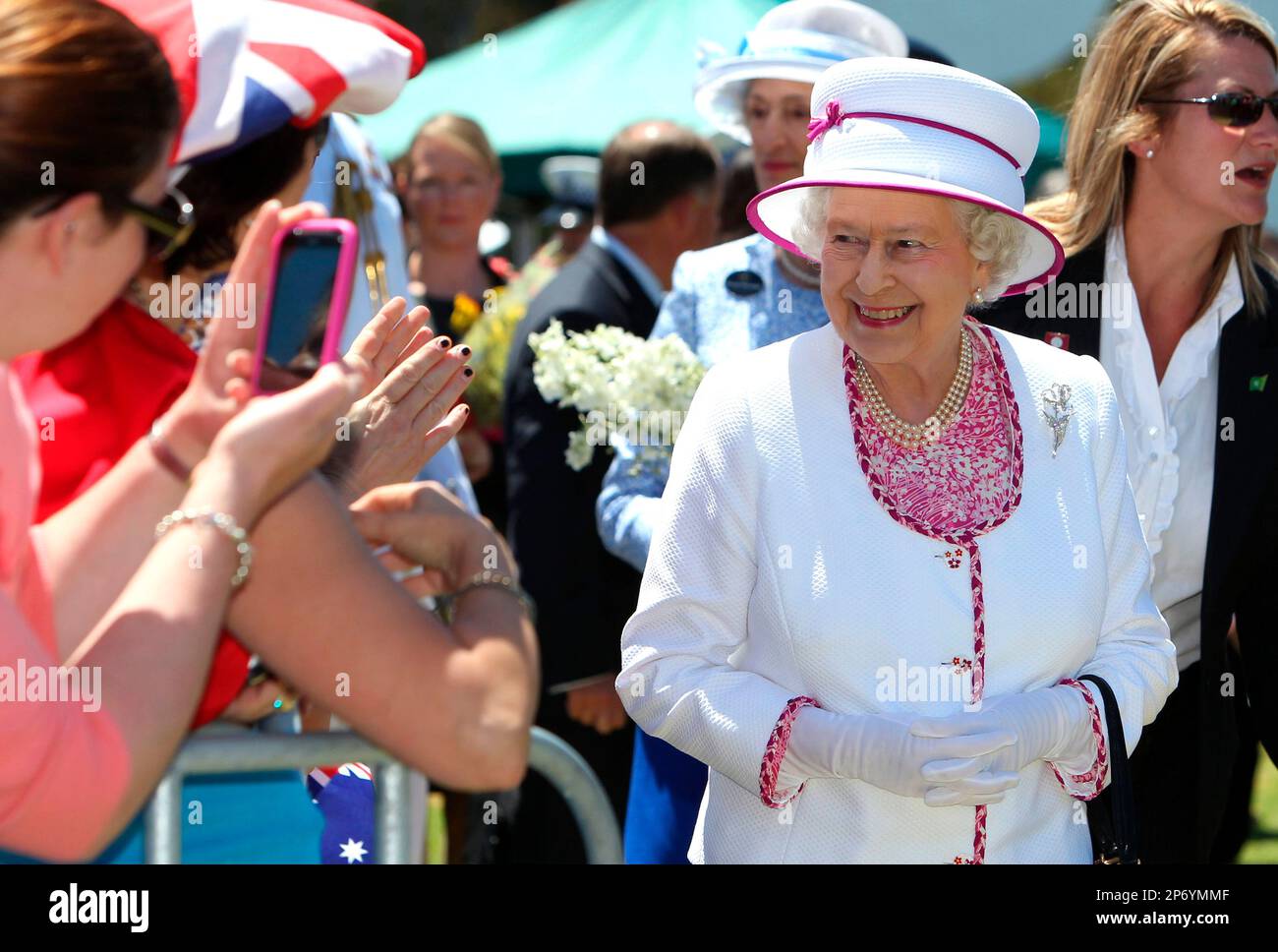 Queen Elizabeth II, has her photo taken as she walks through the crowd ...
